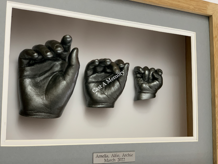 Three hand casts in frame - Cast A Memory